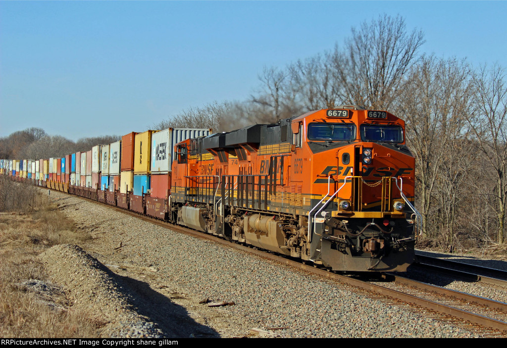 BNSF 6679 Runs dpu with a door left open.